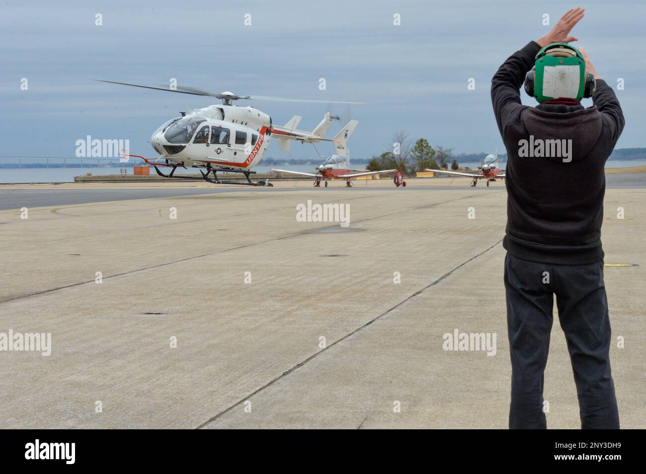 A marshal signals in a U.S. Navy UH-72 Lakota for landing during the U ...