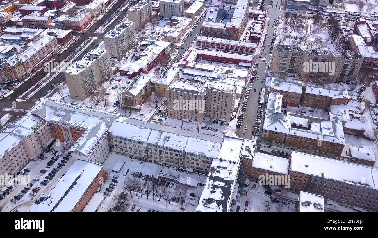 Winter city with high-rise buildings. Clip.View from a helicopter on a ...