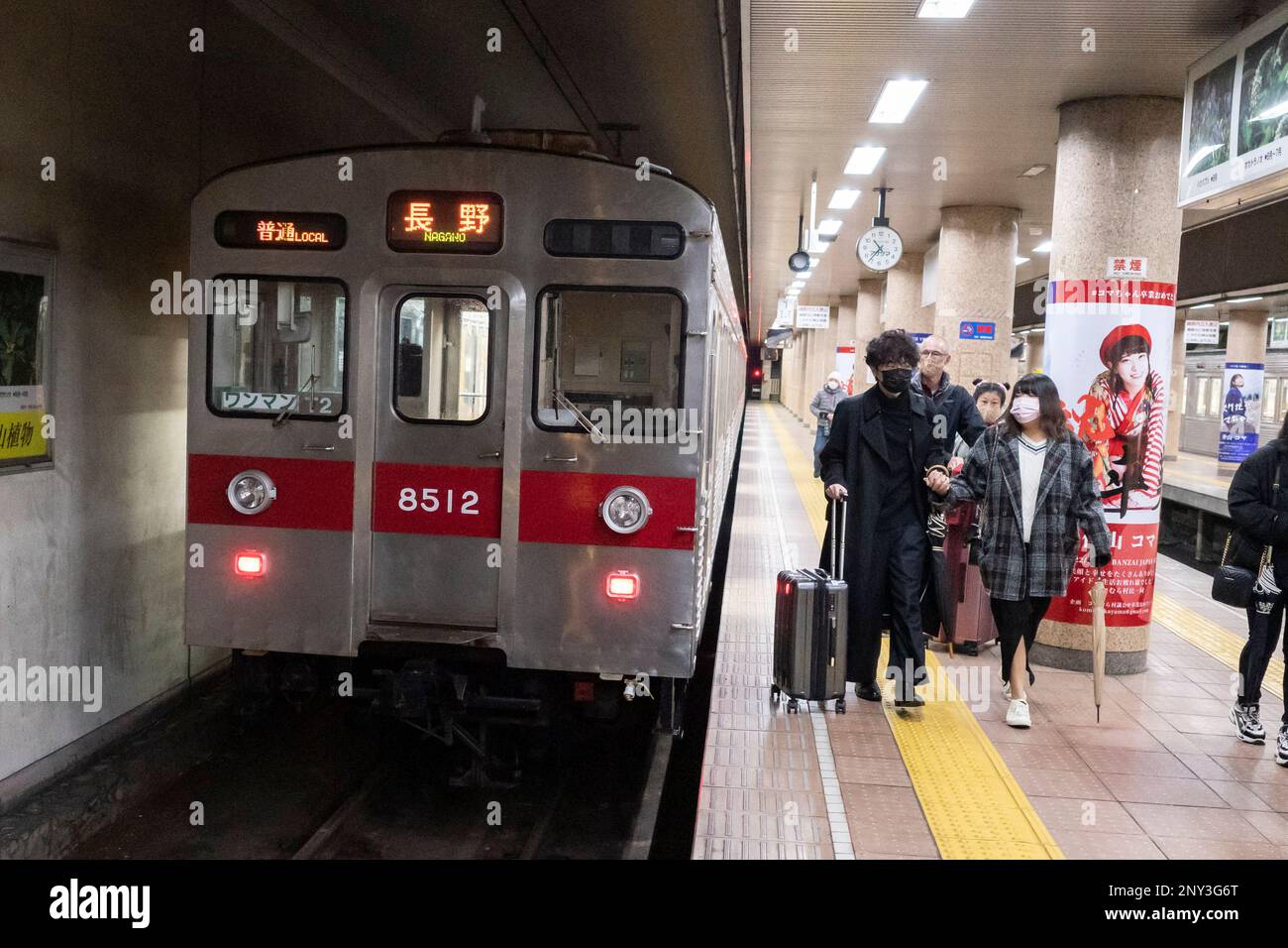 Nagano, Japan. 19th Feb, 2023. Commuters depart the Nagano Electric ...