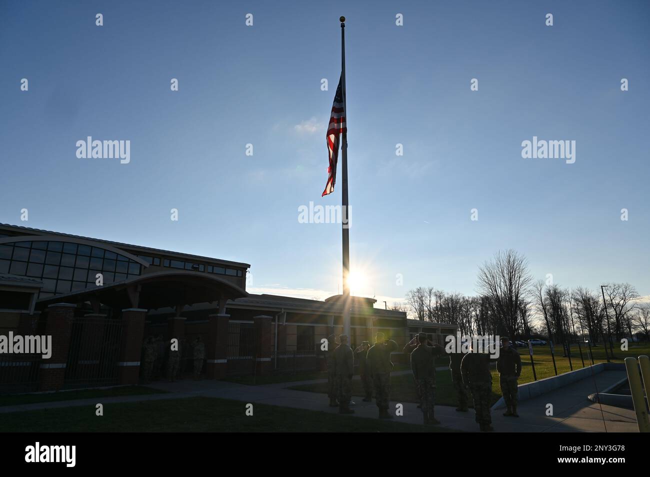 Members of the 174th Attack Wing lower and fold the flag during a ...