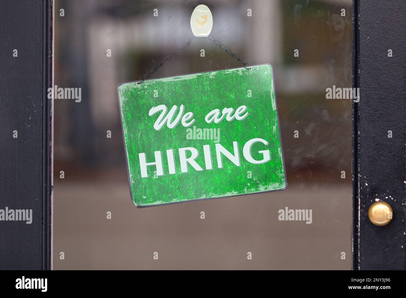 Closed sign with written in it: "We are hiring Stock Photo - Alamy