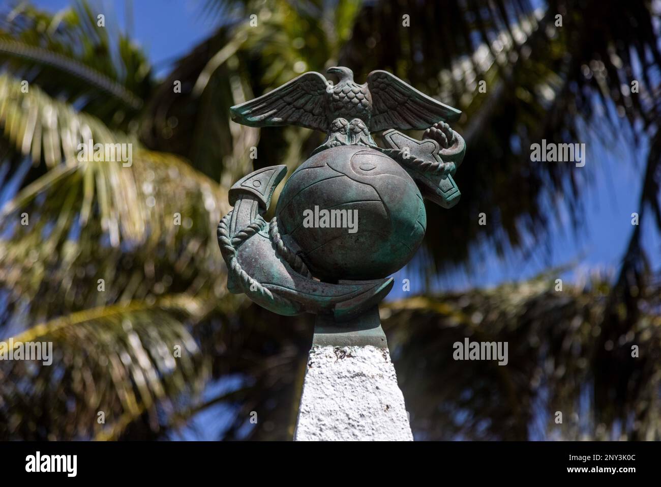An eagle globe and anchor sits on top of a monument memorializing the ...