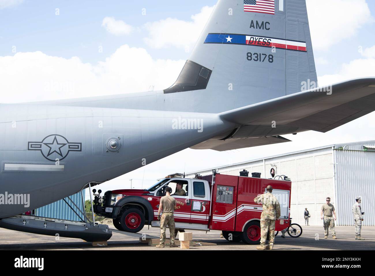 U.S. Airmen unload a P-34 Rapid Intervention Vehicle from a C-130J ...