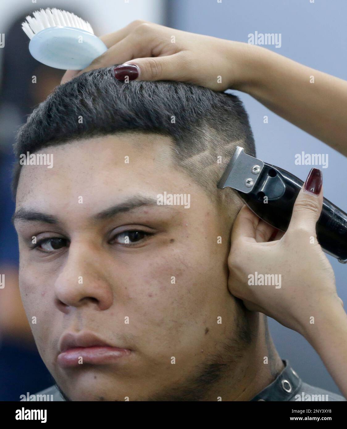 Astros fan Albert Sanchez, shown reflected in a mirror, watches as ...