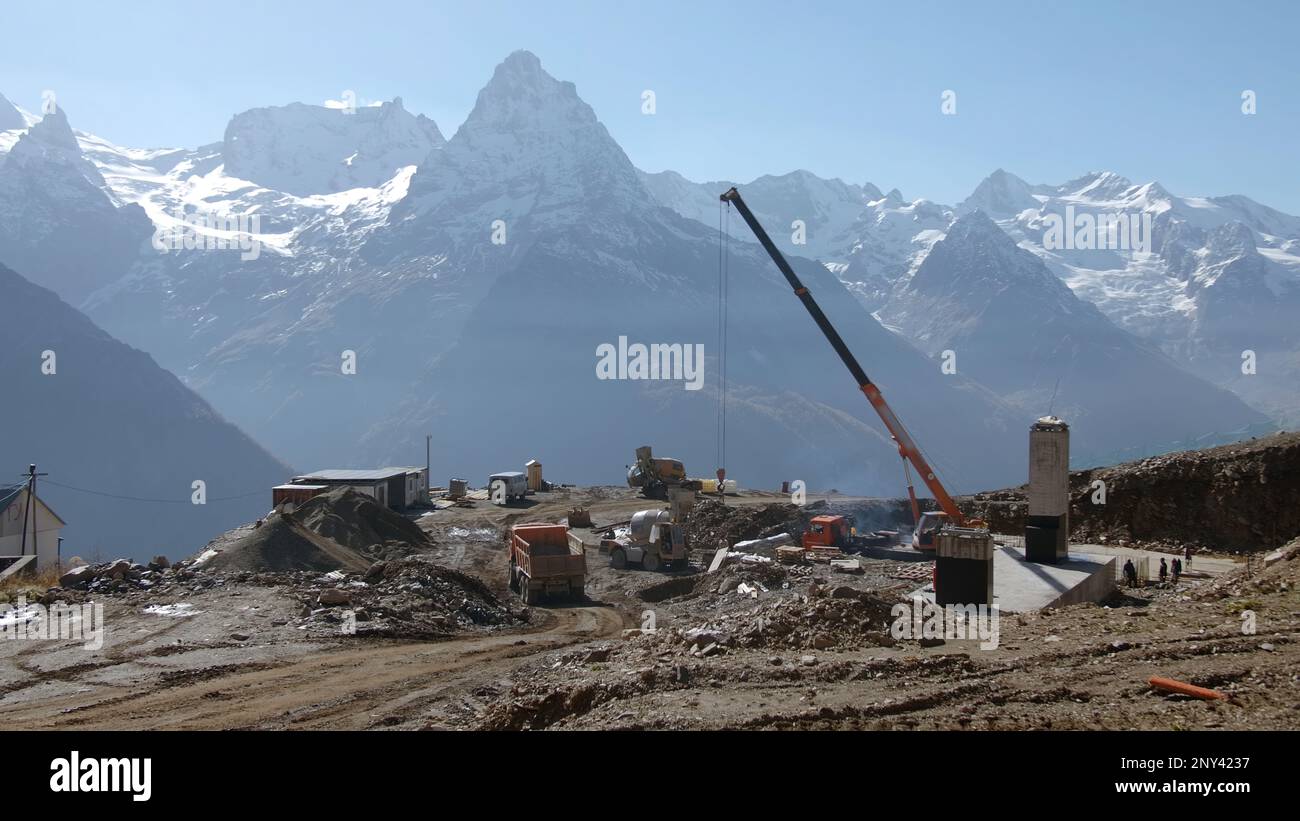 Construction site on background of mountain peaks. Creative ...