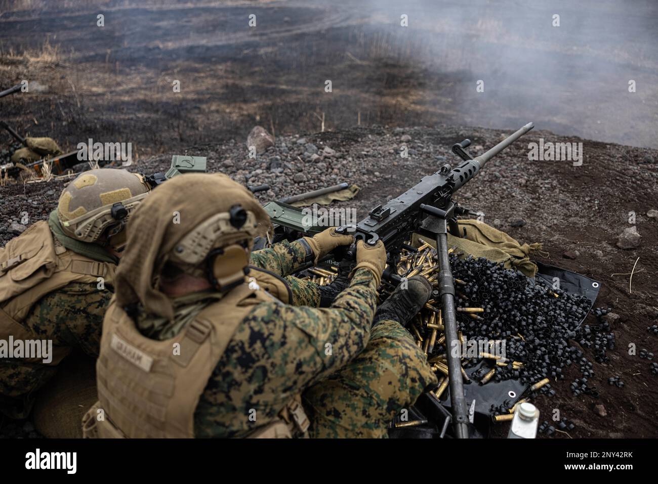 U.S. Marines with 3d Battalion, 4th Marines fire an M2A1 machine gun ...
