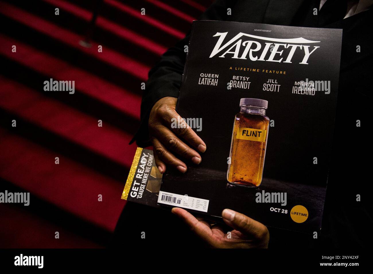 Detroit chauffer Brian Gary stands alongside the red carpet holding the ...