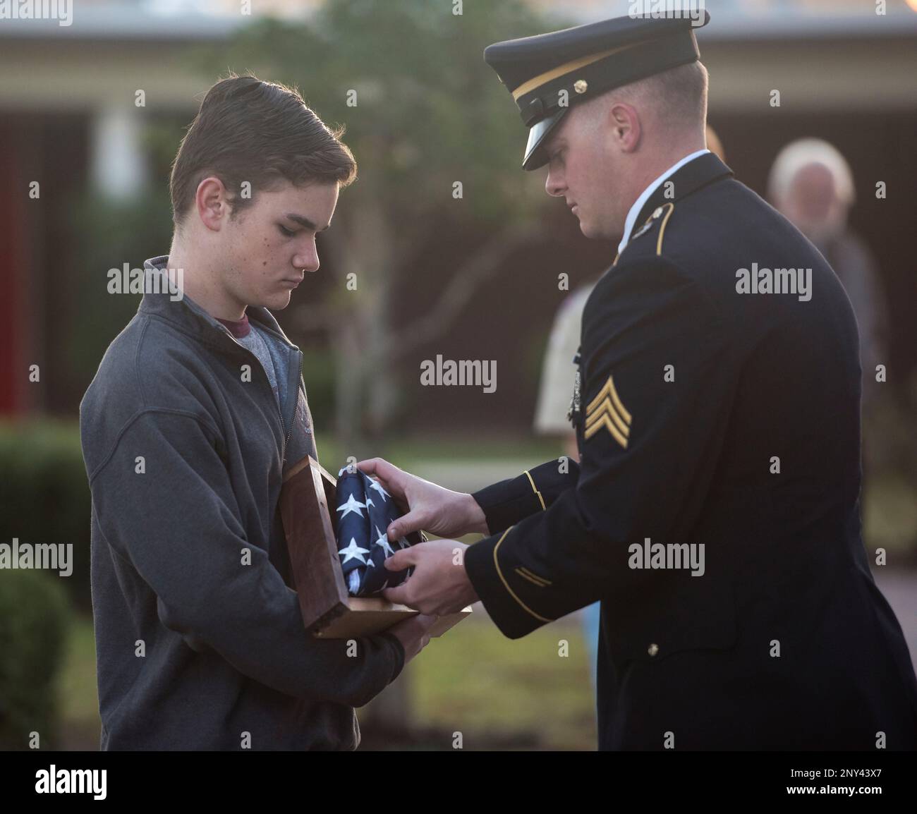 Robert E. Lee High School senior Karl Hall receives a folded flag ...