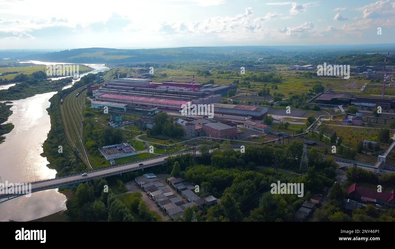 Top view of small factory town by river. Clip. Beautiful landscape with ...