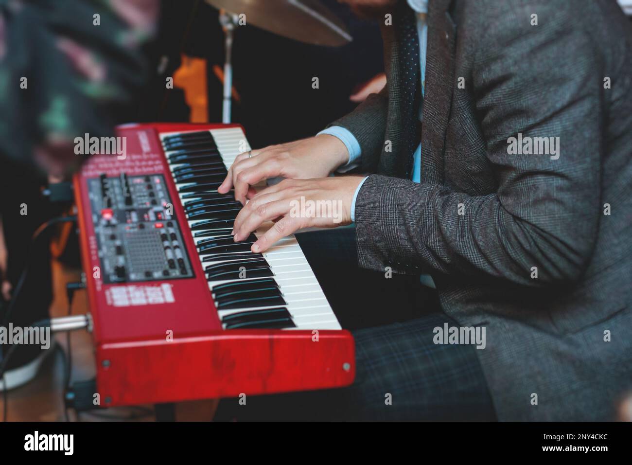 Concert view of a musical keyboard piano player, pianist during musical ...