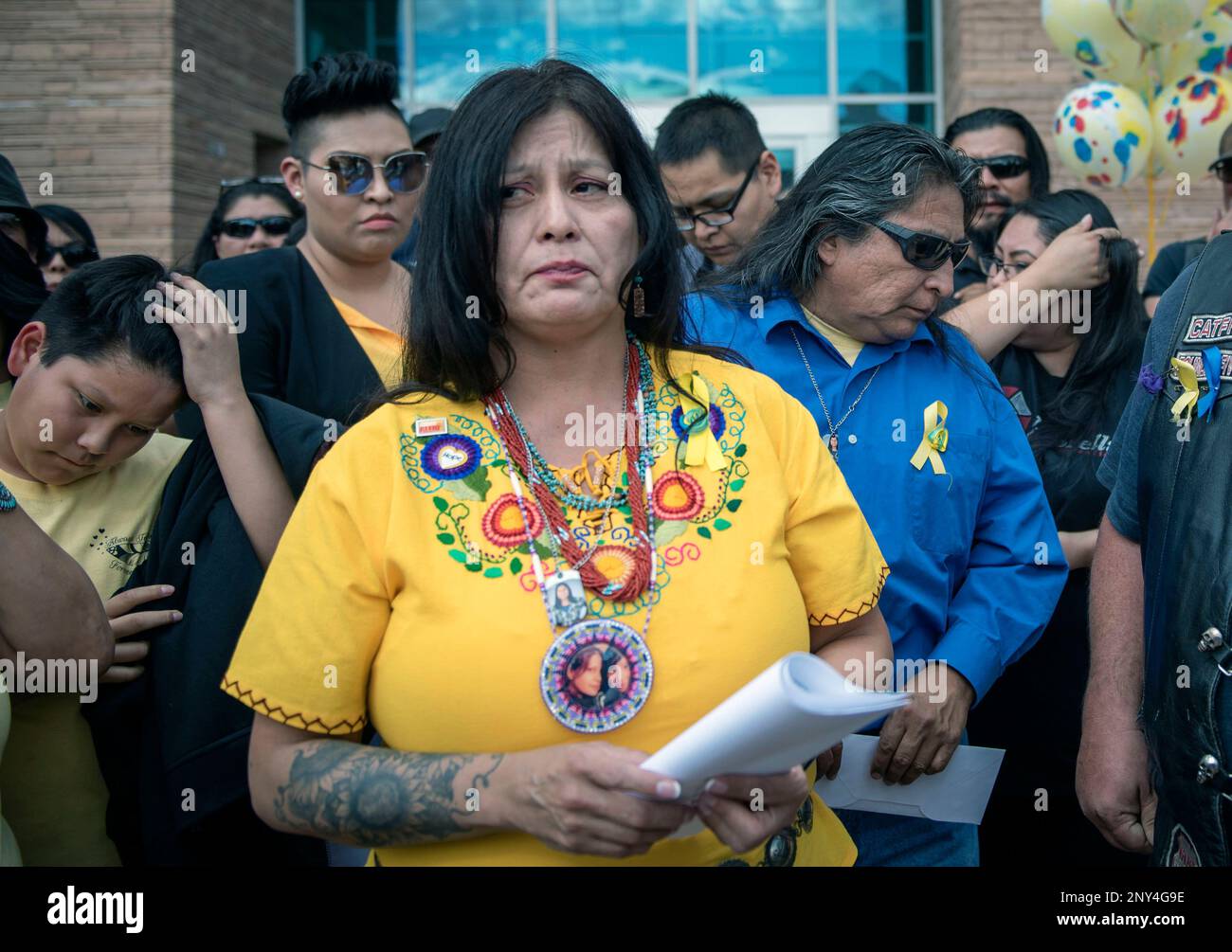 Pamela Foster, foreground, and Gary Mike, center background, parents of ...