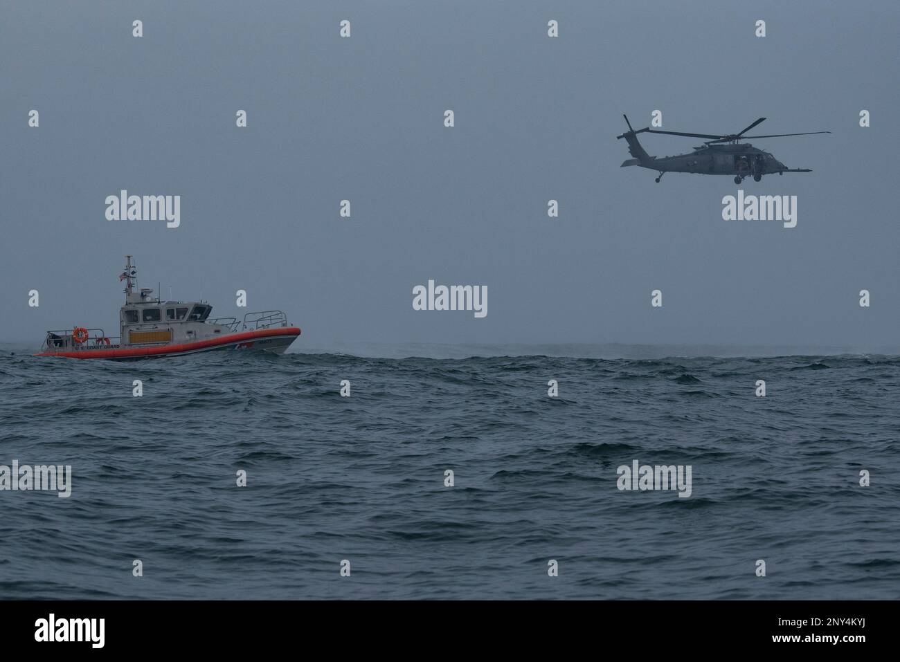 An HH-60W Jolly Green II helicopter prepares for a hoist operation near ...