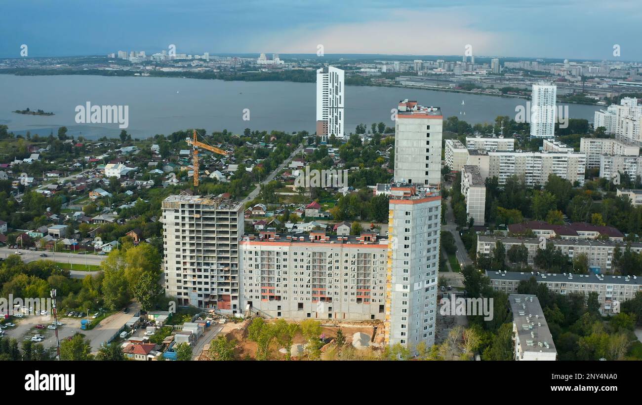 Top view of construction site of house on background of city with river ...