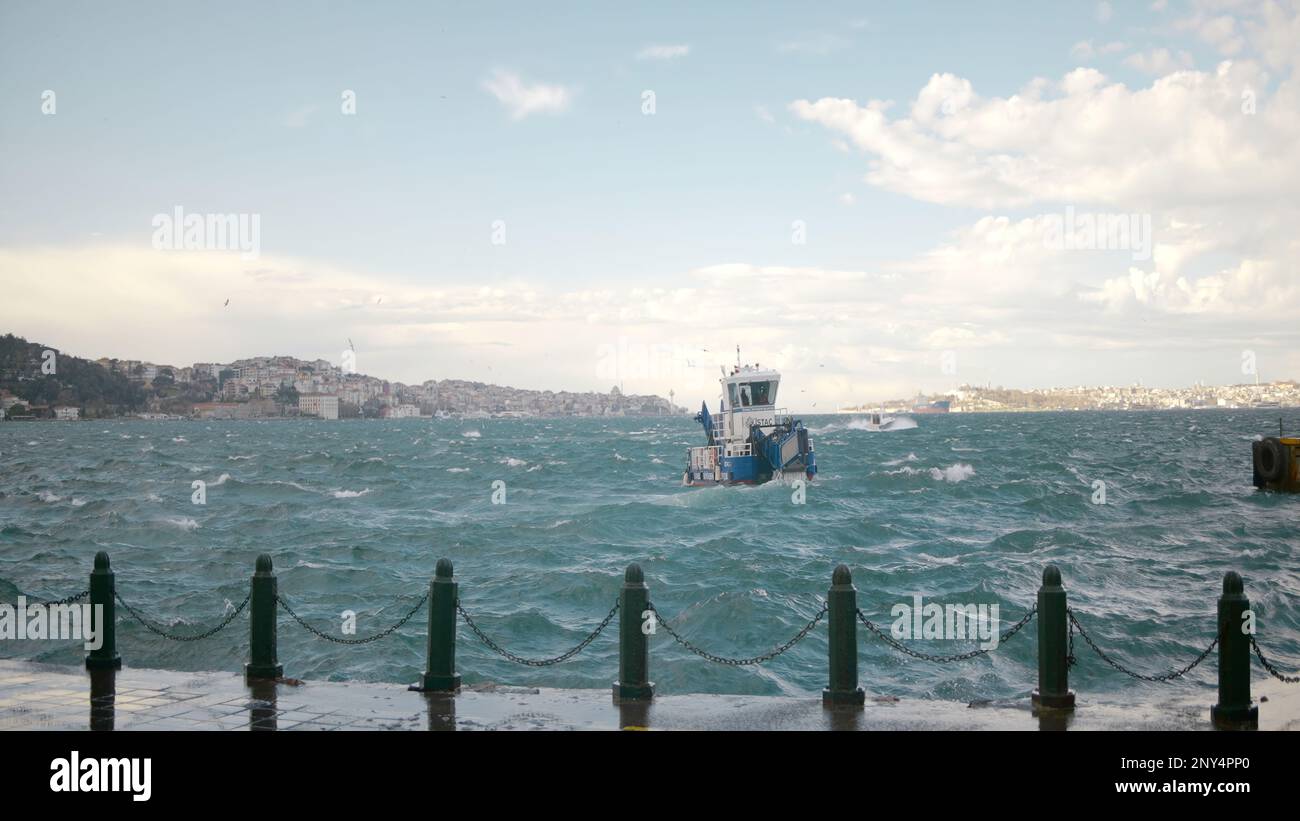 Seascape. Action.A blue undulating sea on which a white ship sails and ...