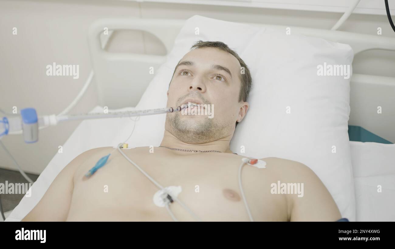 In the operating room. Action. A man lying in a hospital who is looking ...