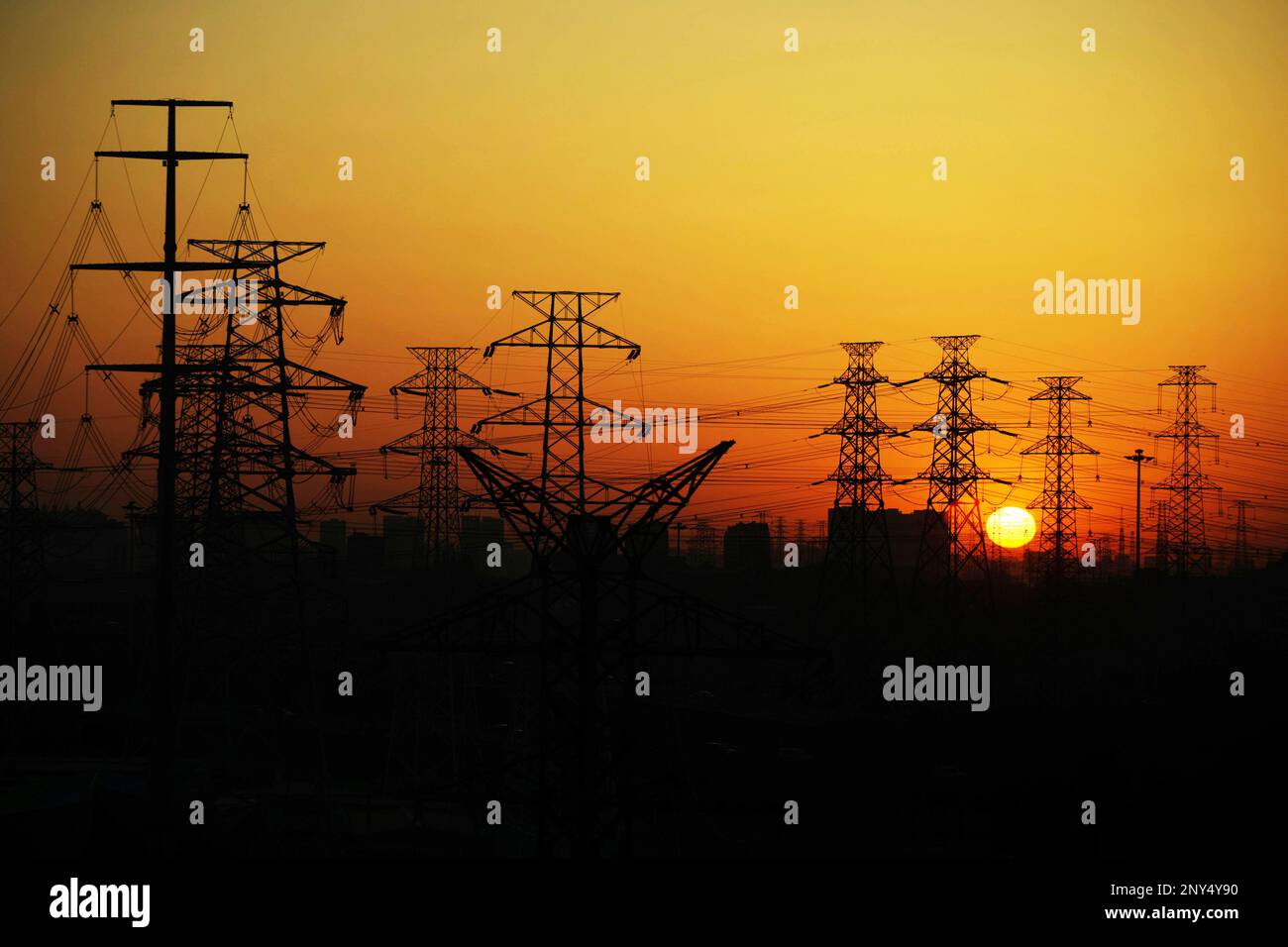 A photo shows power transmission lines in the morning sun in Beijing ...
