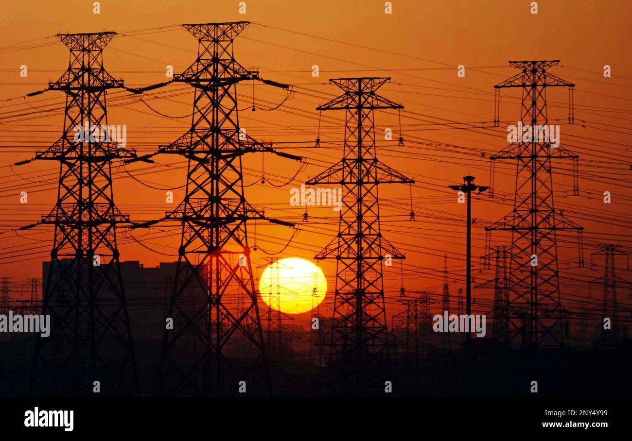 A photo shows power transmission lines in the morning sun in Beijing ...