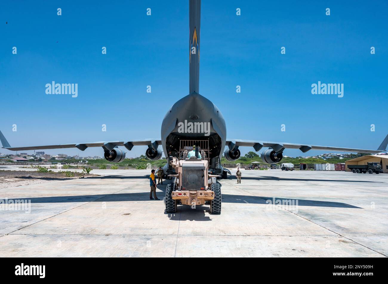 U.S. personnel assigned to the 15th Airlift Squadron unload military ...