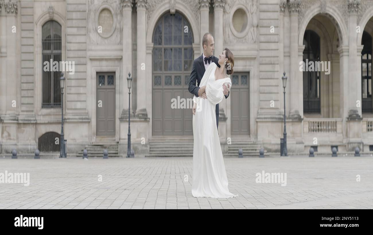 A tall couple in suits posing in the fresh air. Action.A date where ...