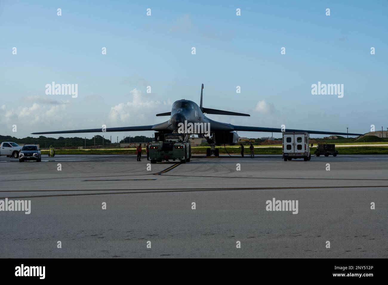 U.S. Airmen from the 34th Expeditionary Bomb Squadron tow and park a B ...