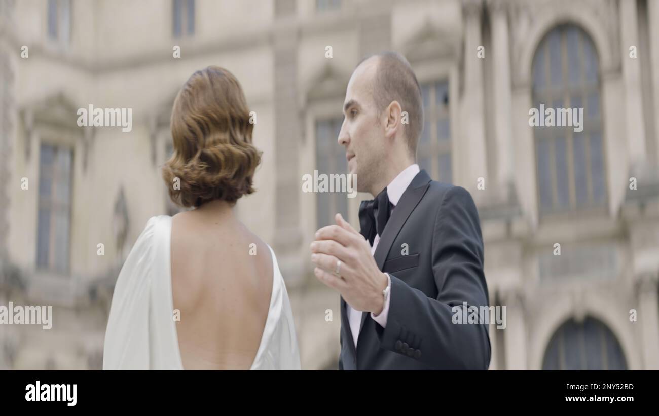 Dancing joyful couple. Action. A beautiful brunette in a white dress ...