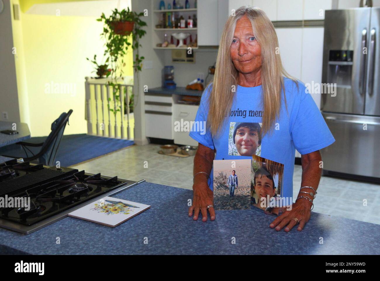 Kate Garrity poses with photos of her son, Patrick, in her home in ...