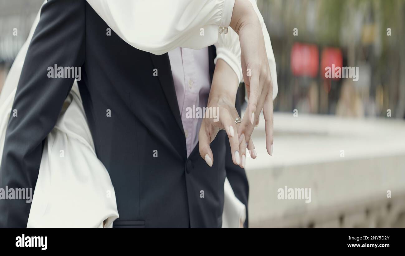 Dancing joyful couple. Action. A beautiful brunette in a white dress ...