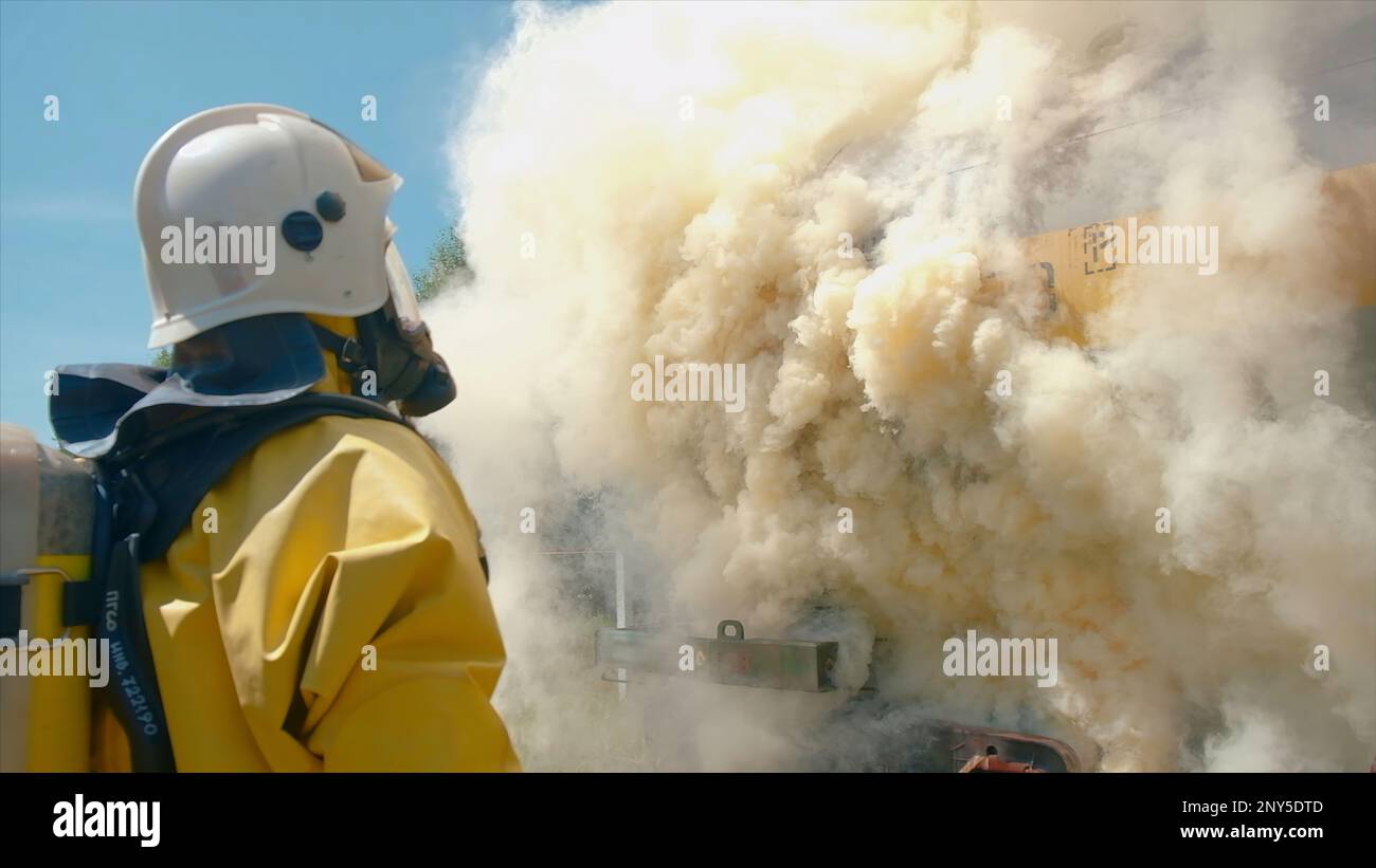 Firefighters on background of heavy smoke. Clip. Firefighters at ...