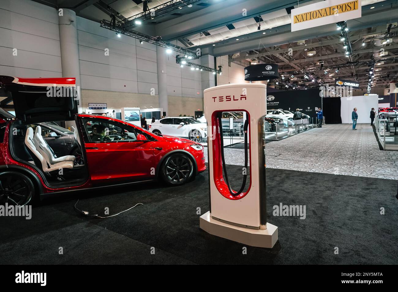 Tesla charging station in the showroom Stock Photo - Alamy