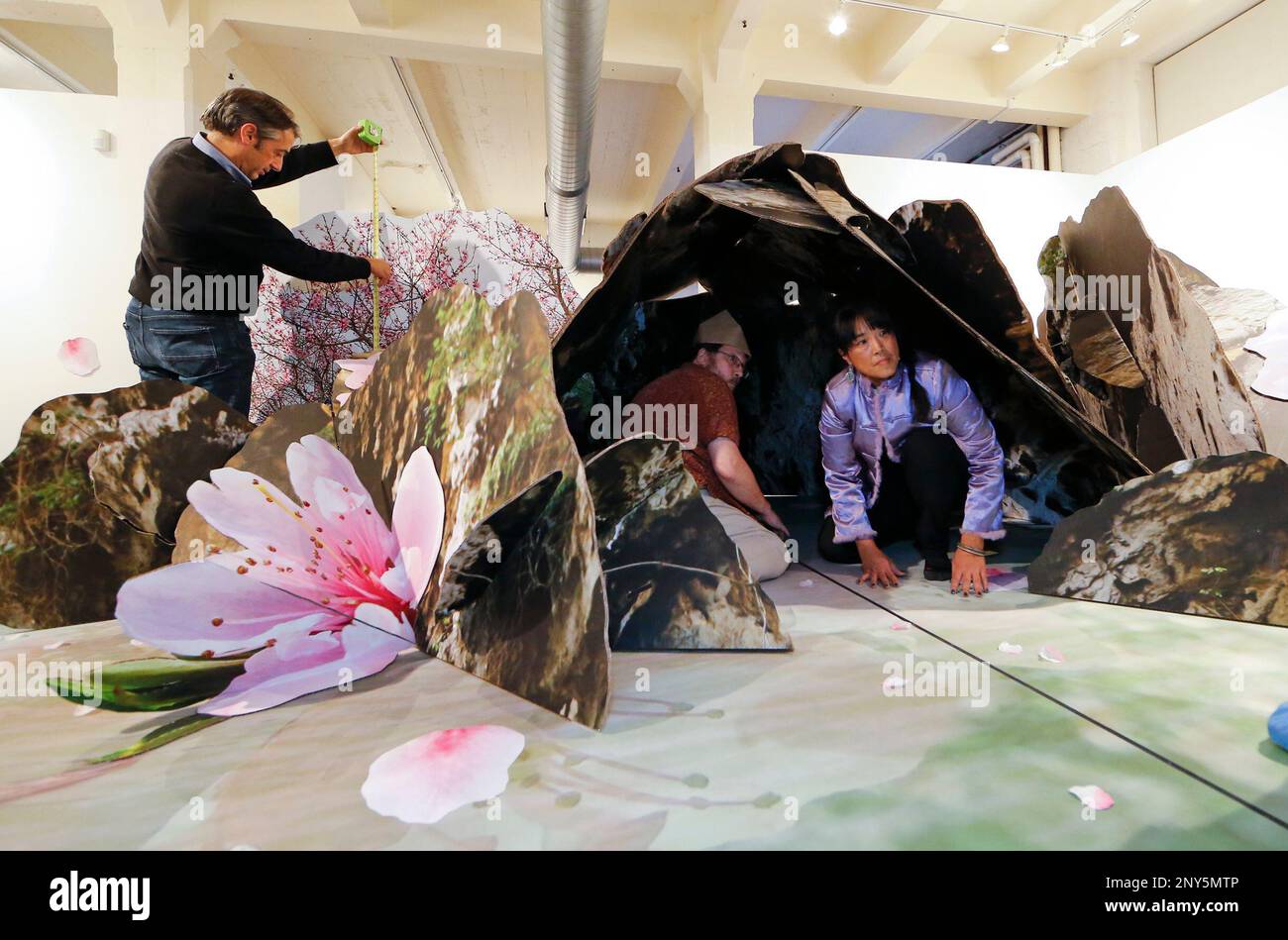 Artist Colette Fu, right, sits in her pop-up photo book titled "Tao Hua ...