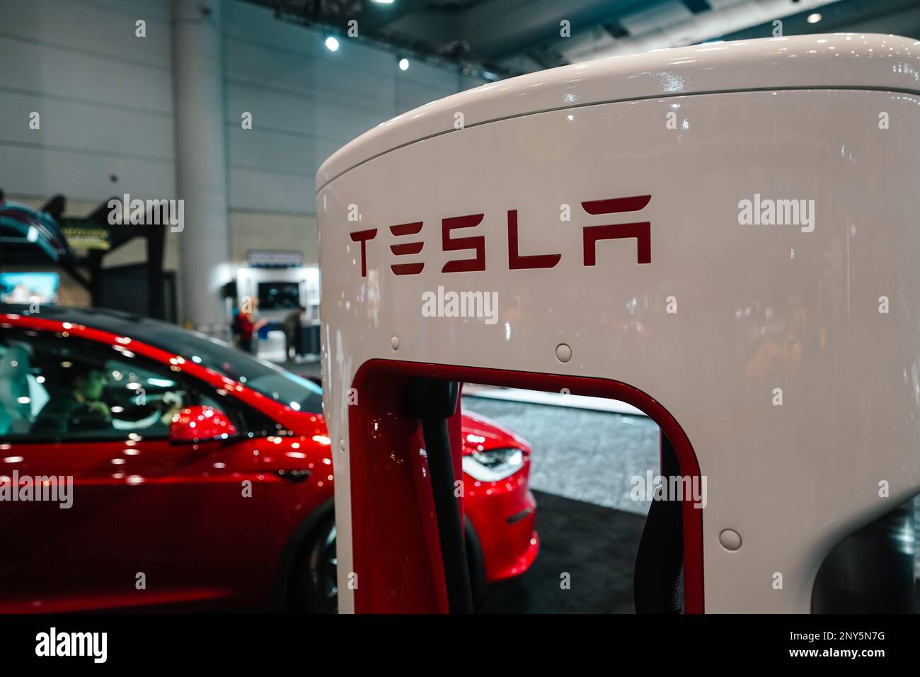 Tesla charging station in the showroom Stock Photo - Alamy