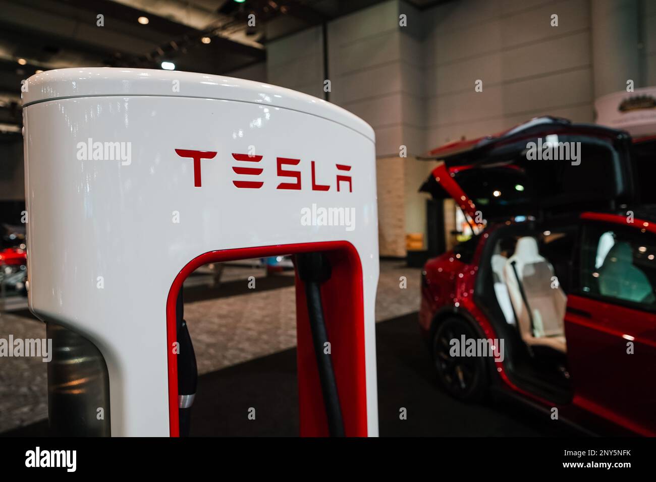 Tesla charging station in the showroom Stock Photo - Alamy