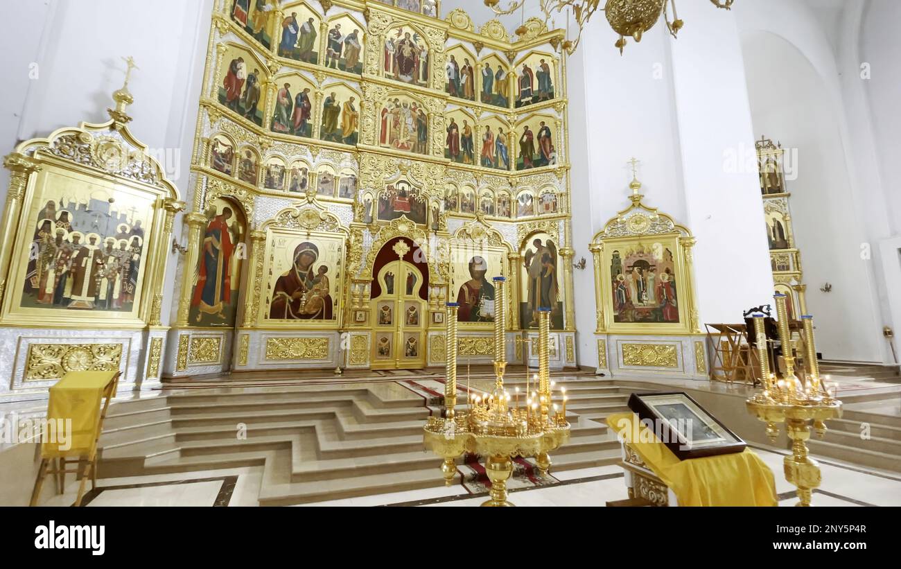 Wall of golden icons in church. Clip. Interior of bright church with ...