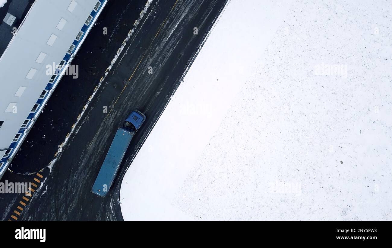 Moving a huge blue truck. Bird's-eye view. Creative. Winter landscape ...