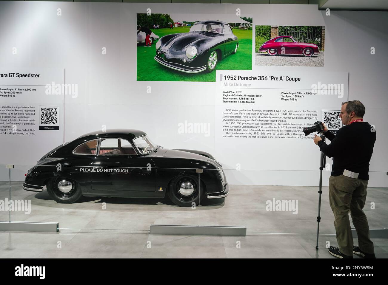 middle aged man taking a photo of a vintage porsche car Stock Photo - Alamy