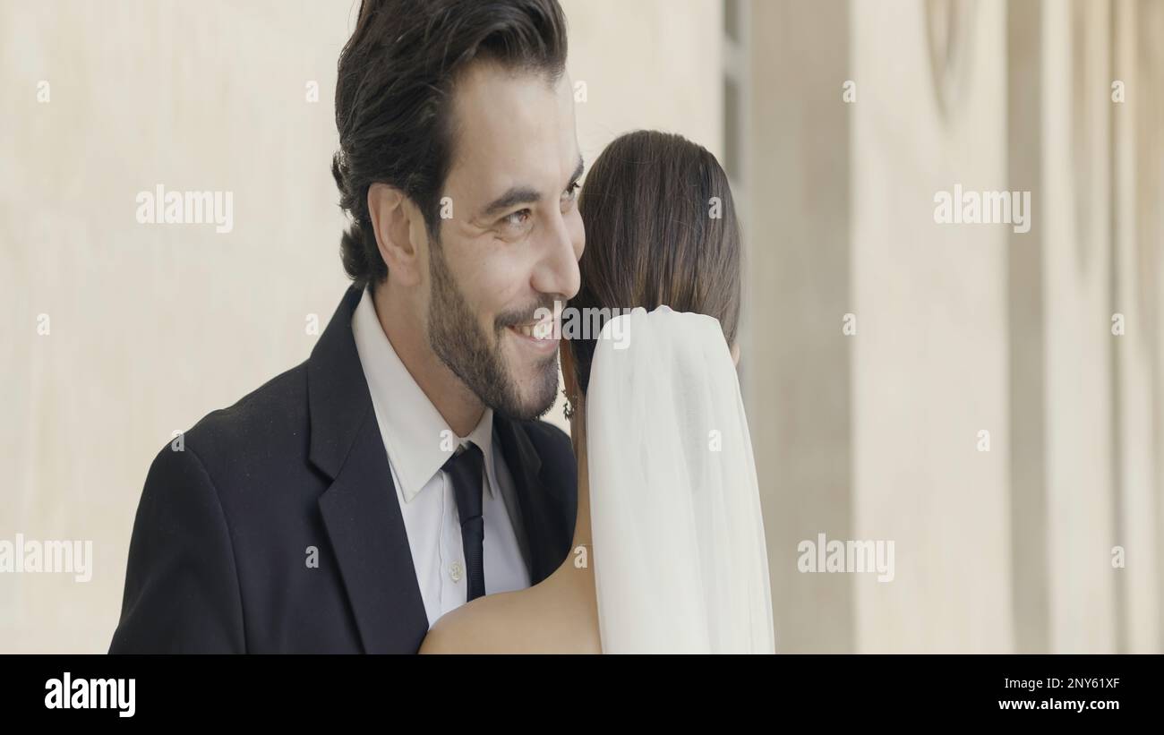 Embracing the bride and groom. Action. A happy smiling couple who are ...