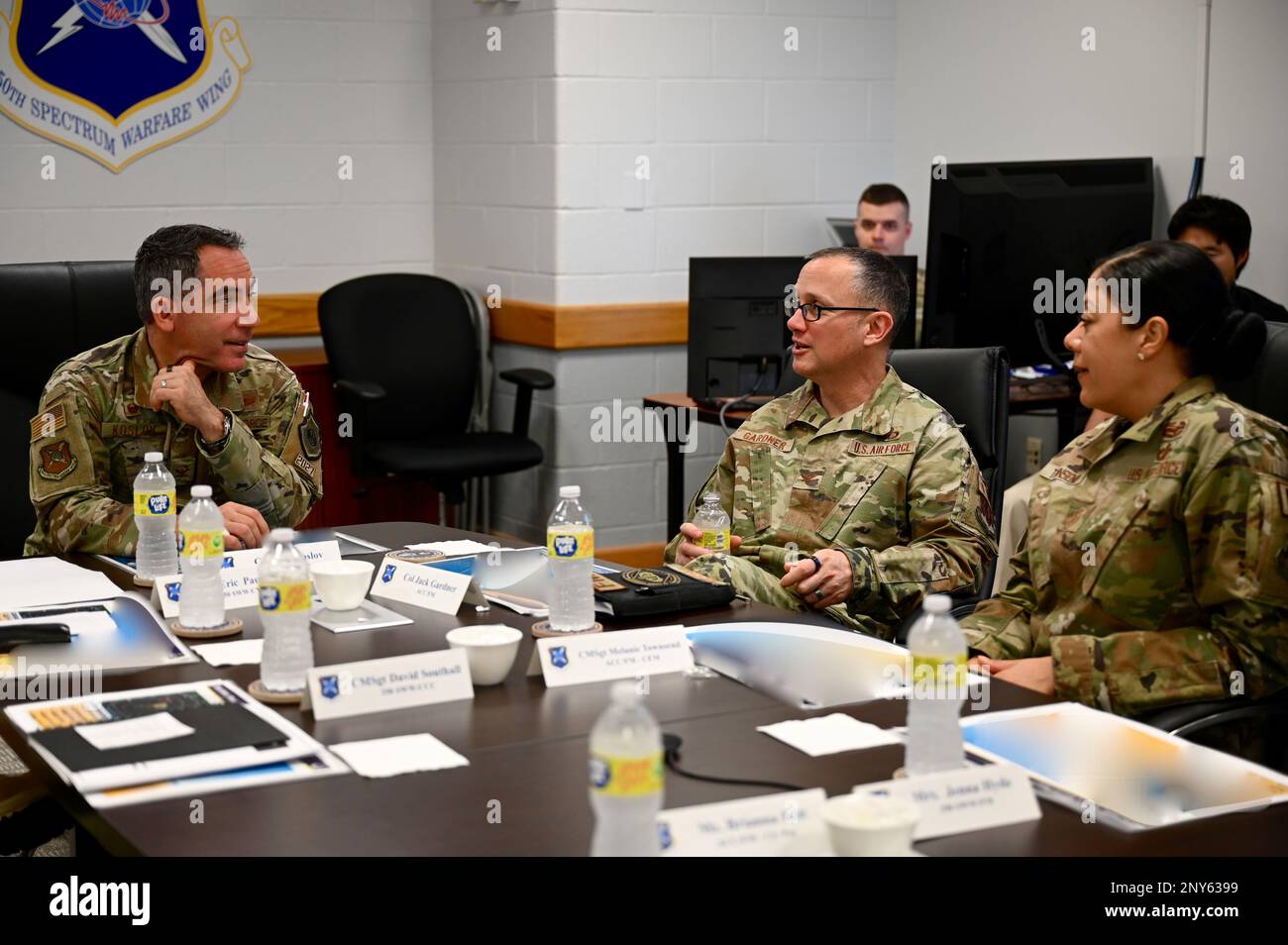U.S. Air Force Col. Josh Koslov, 350th Spectrum Warfare commander, left ...