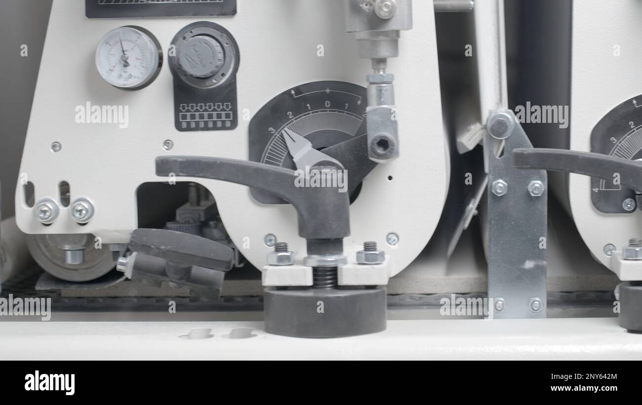 Close-up of conveyor machine with pressure indicator. Creative. Moving ...