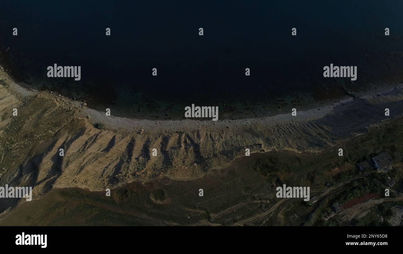 Top view of coast line with blue water. Shot. Wild coast with deep blue ...