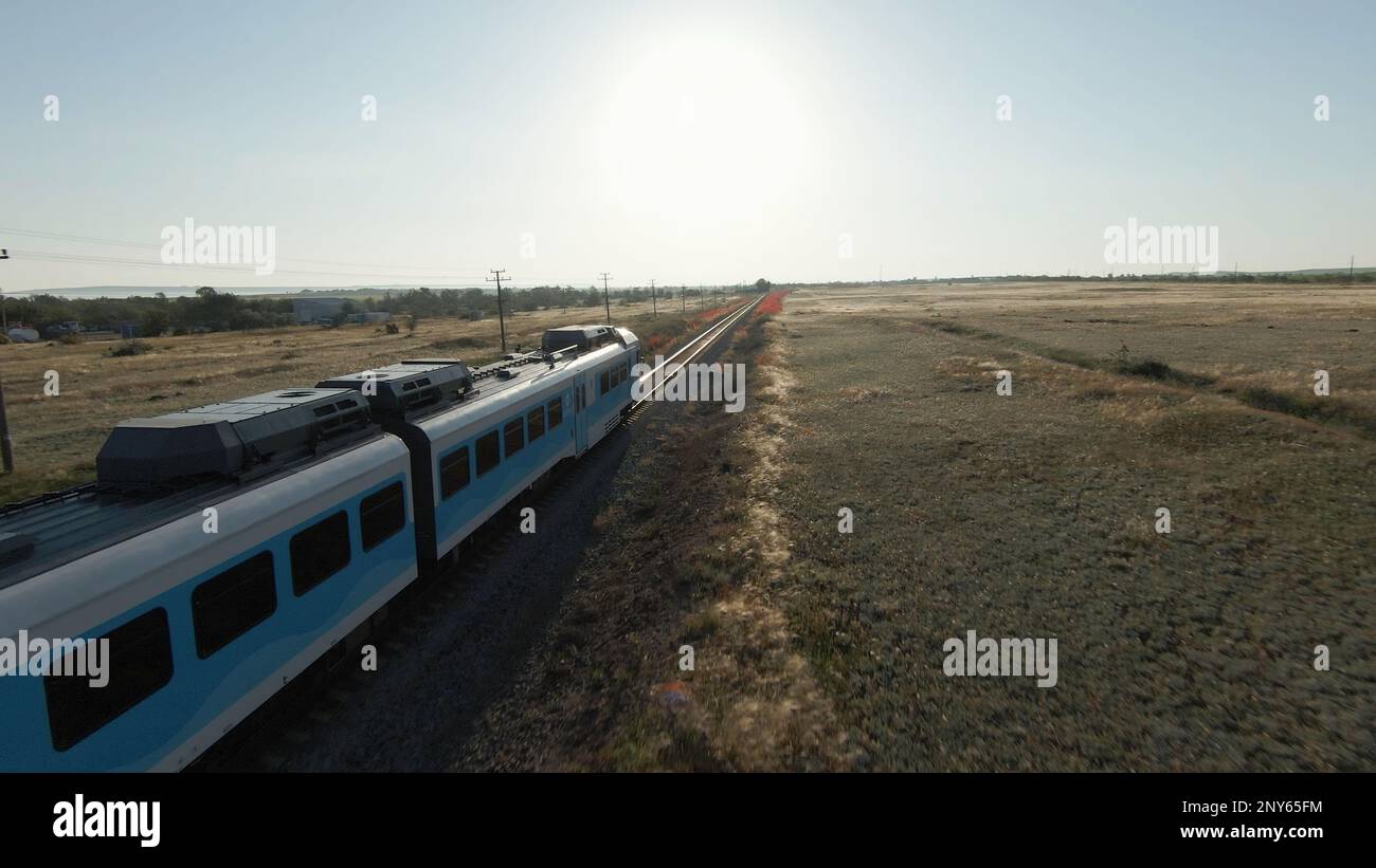 Drone is moving behind train. Shot. Top view of drone following train ...