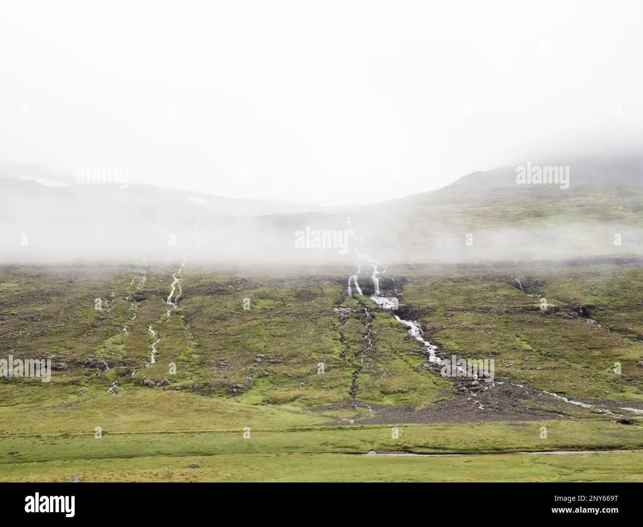 Clouds of fog drift across lonely plateau, near Egilsstadir, Iceland ...