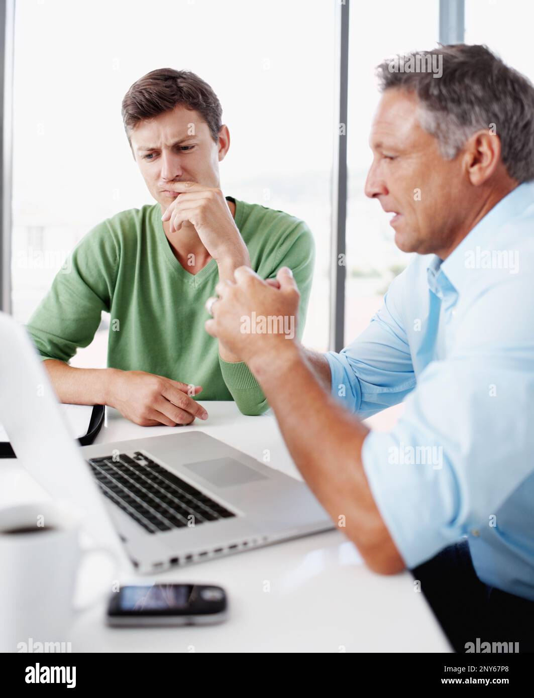 Problem solving together. A mature executive looking over some work on ...