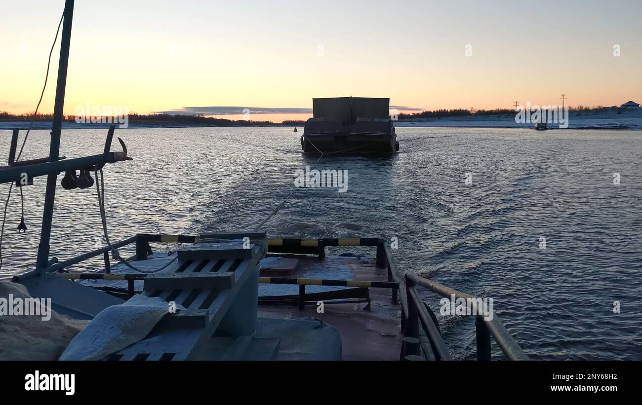 View of cargo floating behind boat on river. Clip. River cargo tug is ...