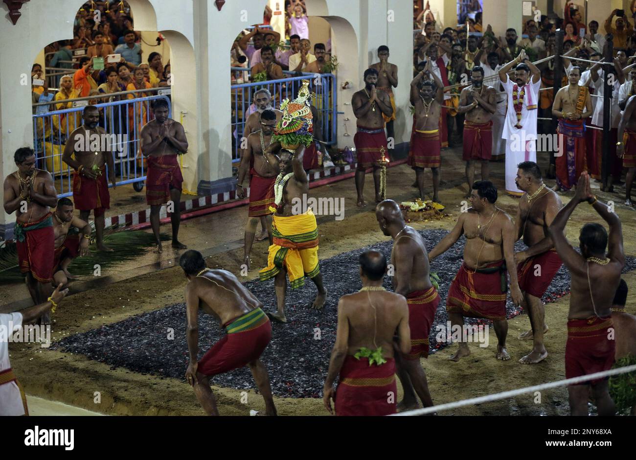 Sri Mariamman Temple's chief priest Swaminathan Pandaram walking across ...