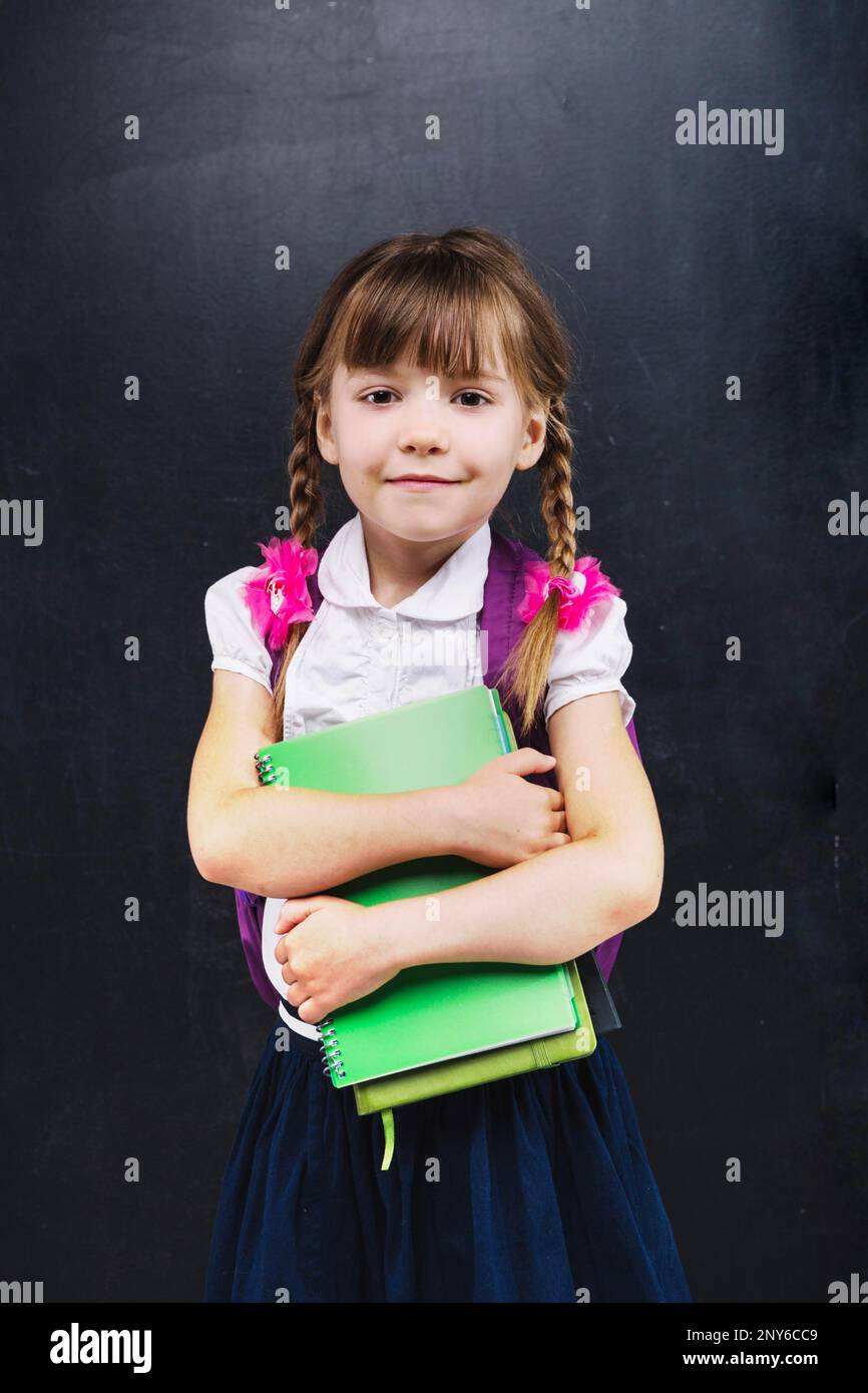 Little schoolgirl with books Stock Photo - Alamy
