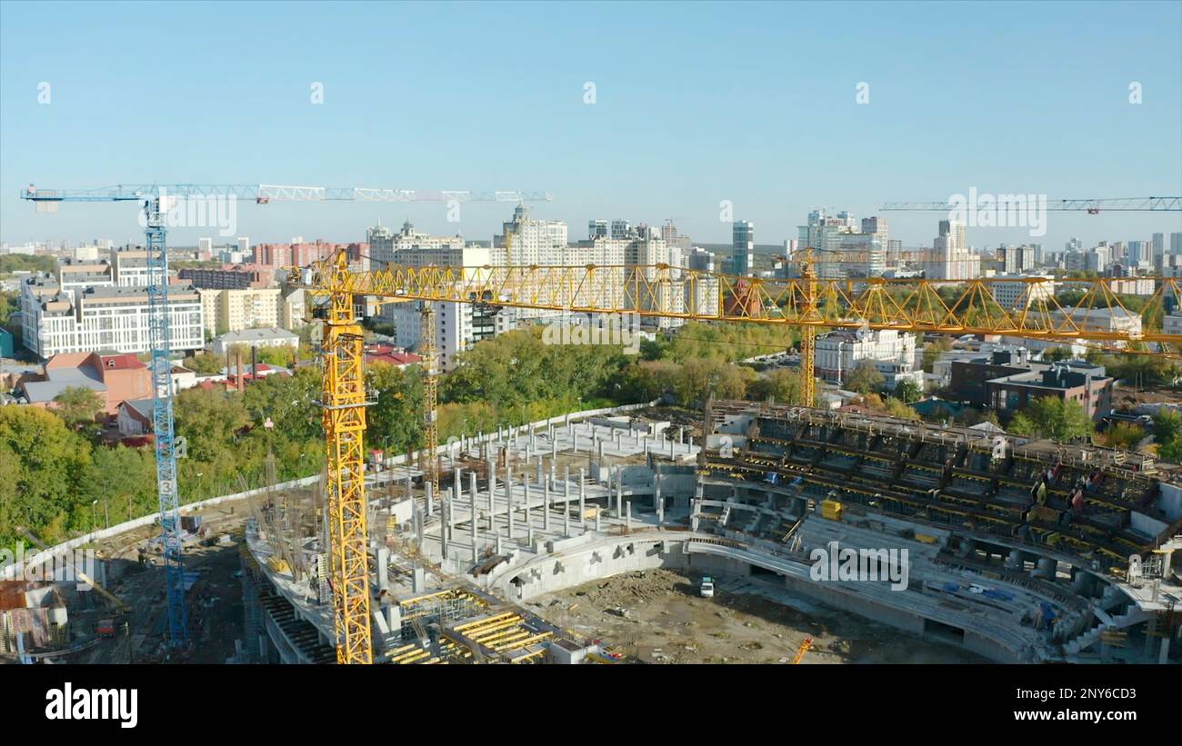 Top view of construction of sports arena with cranes. Stock footage ...