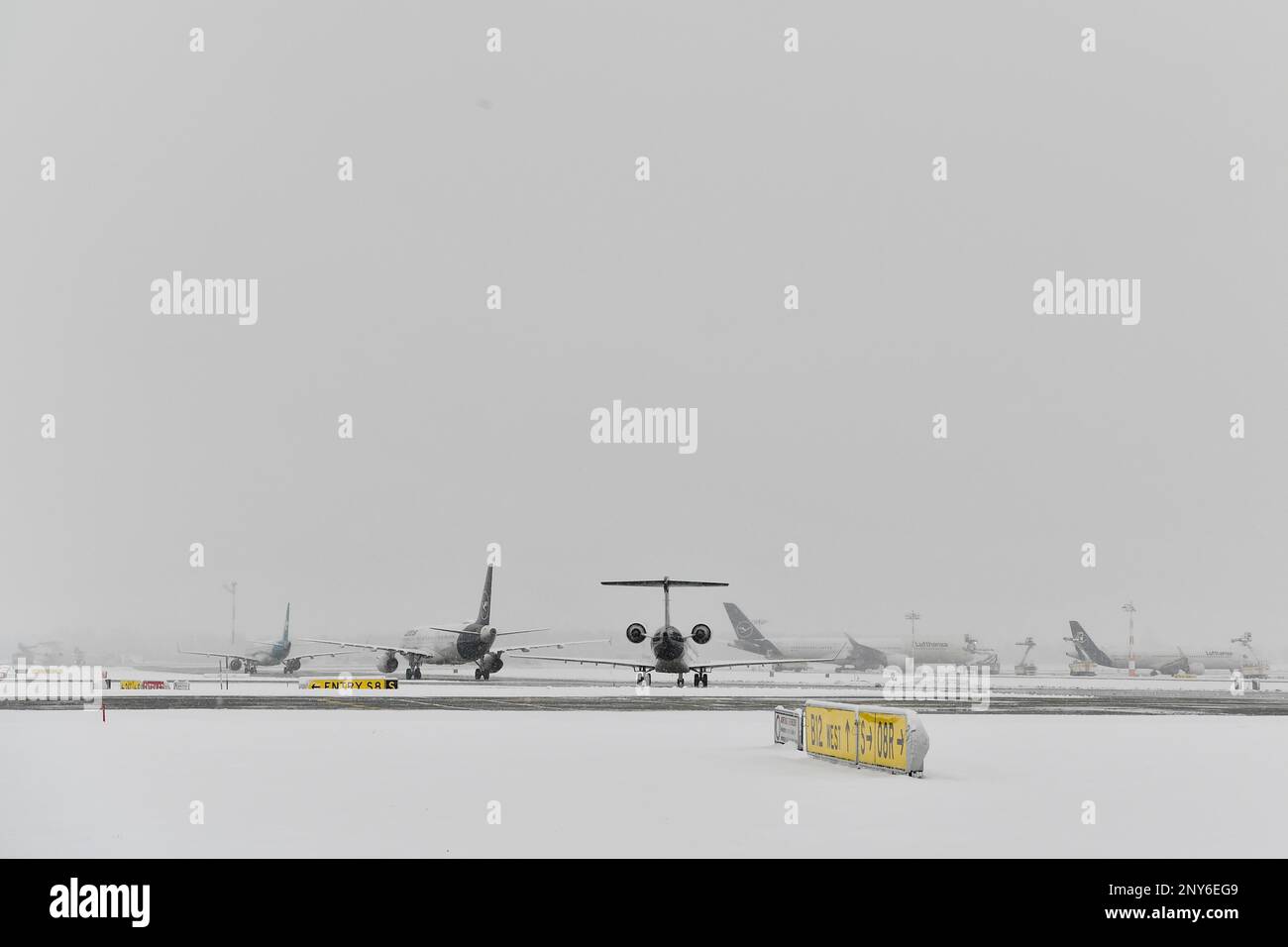 Aircraft in wait in winter snow flurry for de-icing and take-off ...