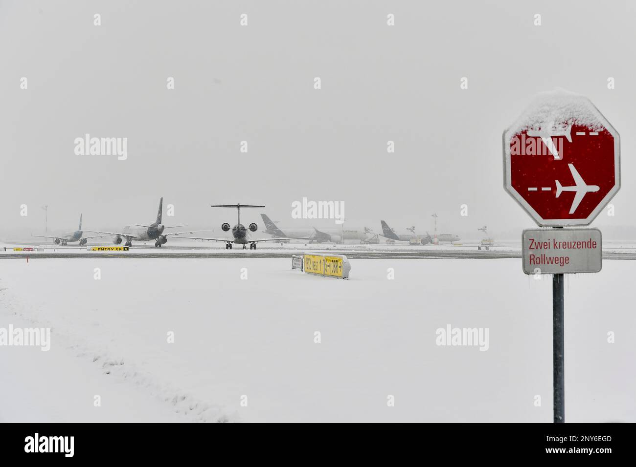 Aircraft in wait in winter snow flurry for de-icing and take-off ...