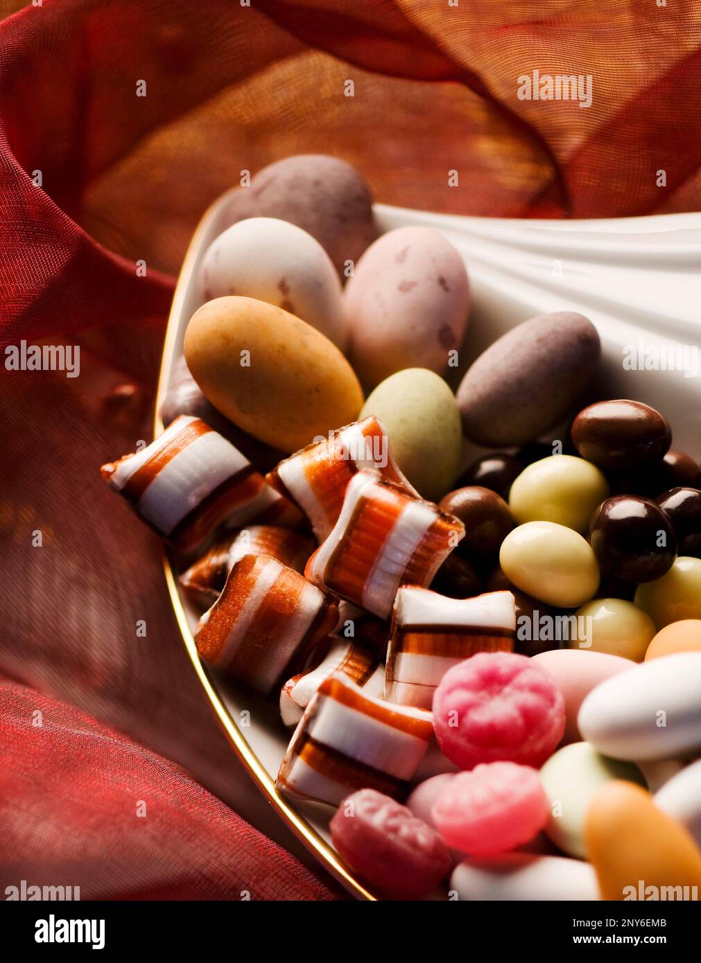 Sweets in bowl with fabric background Stock Photo - Alamy