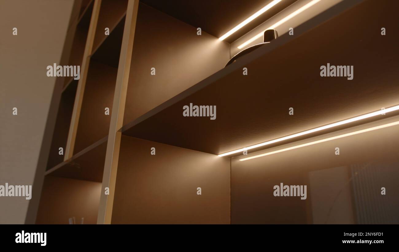 Glowing cabinet shelves. Stock footage. Modern interior design with ...